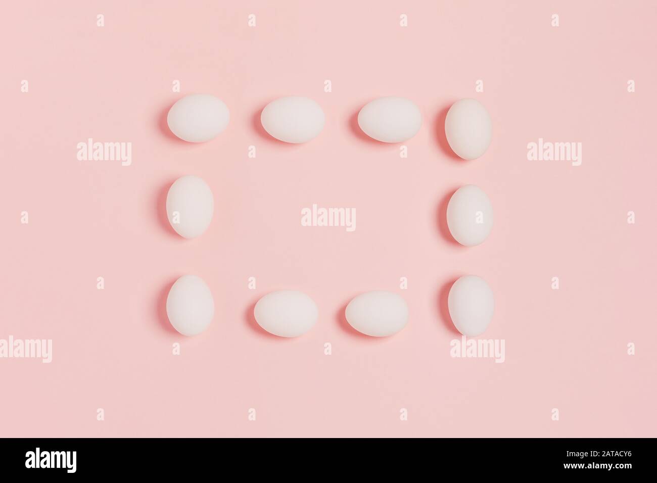 Happy Easter. Rectangular frame made of white eggs on pink background ...