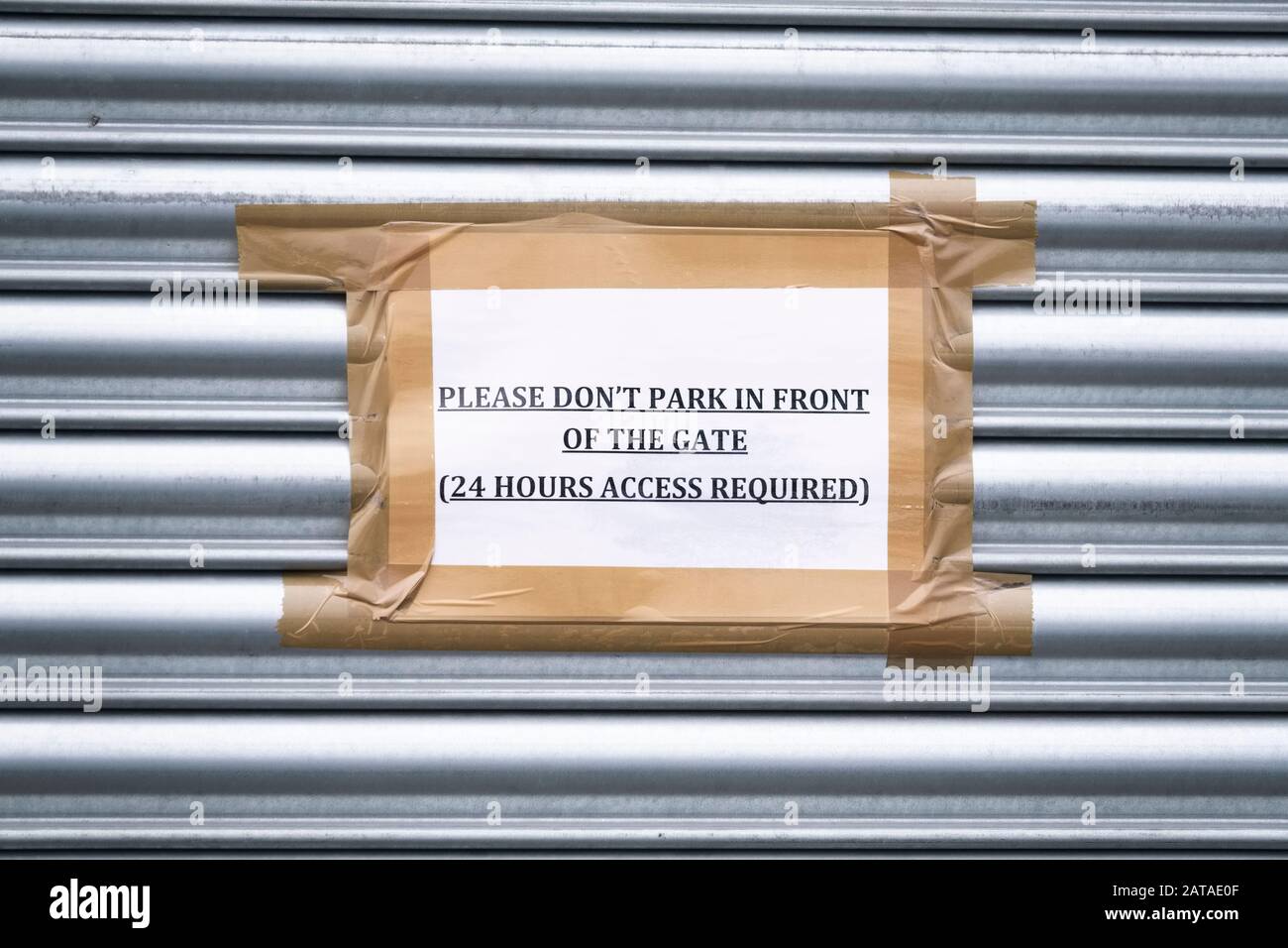 No parking keep clear sign with gate entrance door at constant use ...