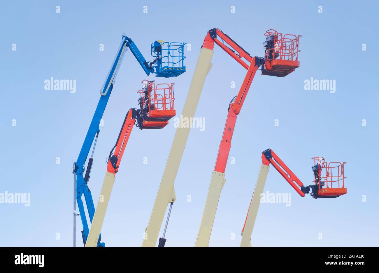 Access platform equipment powered high in sky in blue orange and yellow ...