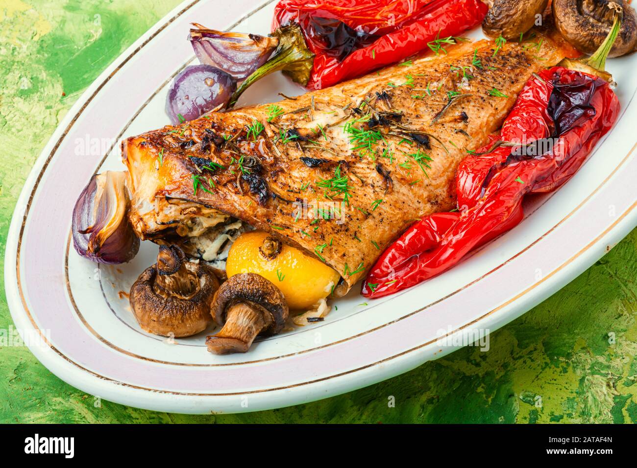 Red sea bass baked with mushrooms and red pepper.Fish in roasted ...