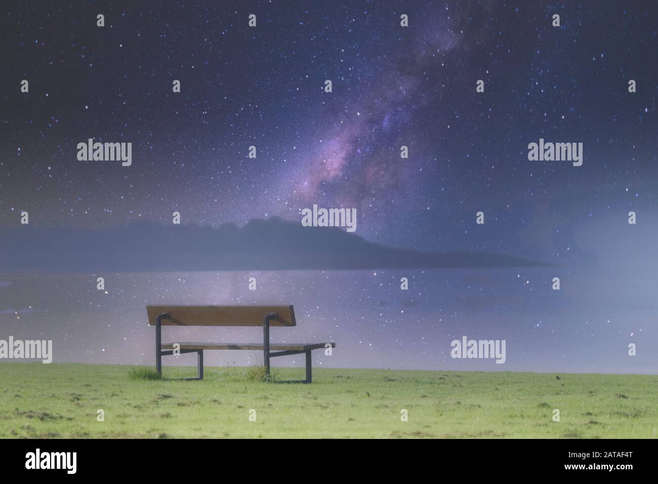 Lonely empty bench in open tranquil landscape by the sea with night ...