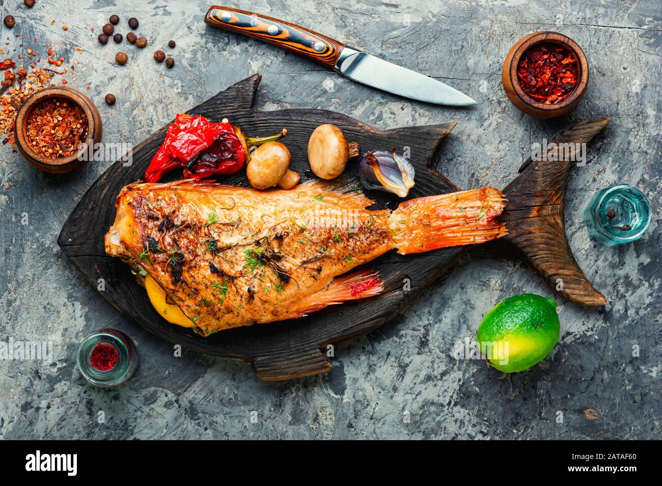 Red sea bass baked with mushrooms and red pepper.Fish in roasted ...