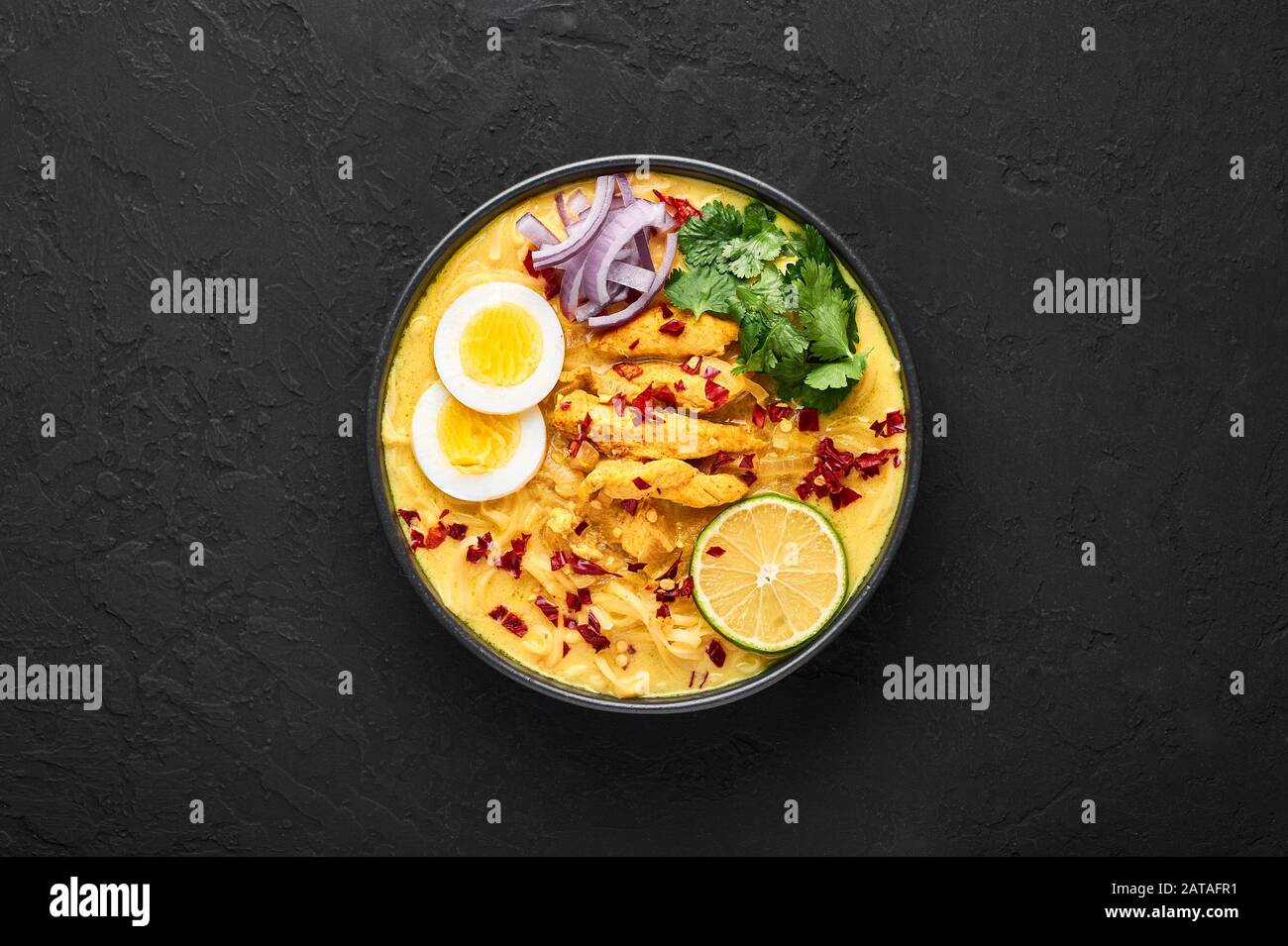 Ohn No Khao Swe in black bowl at dark slate background. Oh No Khao Suey ...