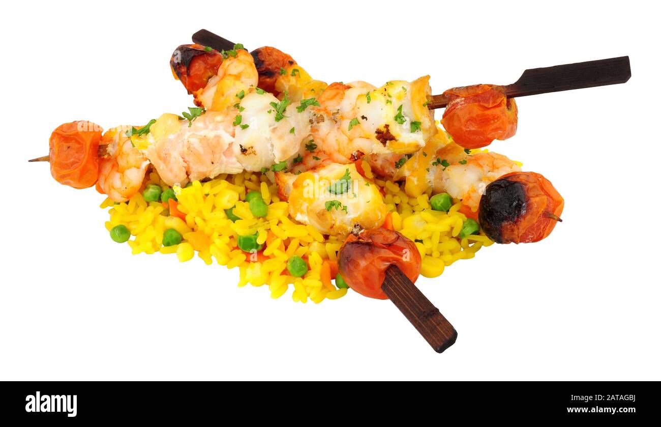 Grilled fish kebabs with rice and vegetables isolated on a white ...