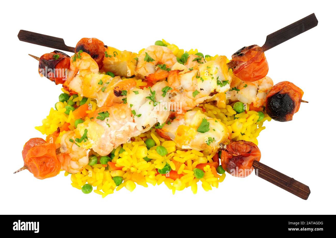 Grilled fish kebabs with rice and vegetables isolated on a white ...