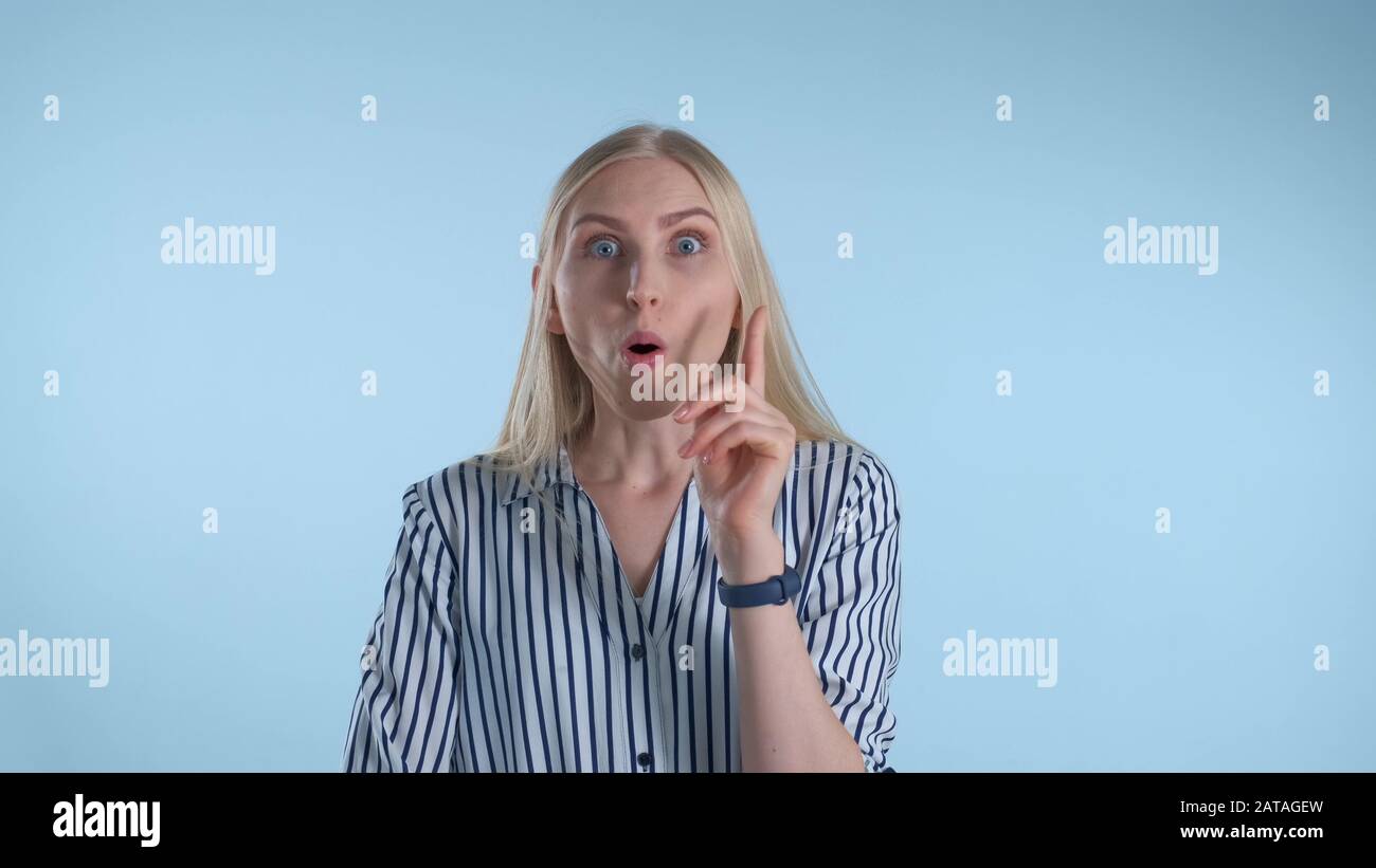 Intelligent young woman suddenly comes to an excellent idea. Blue ...