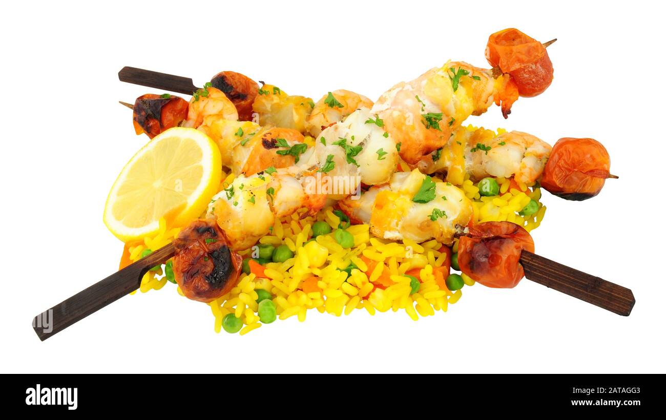 Grilled fish kebabs with rice and vegetables isolated on a white ...