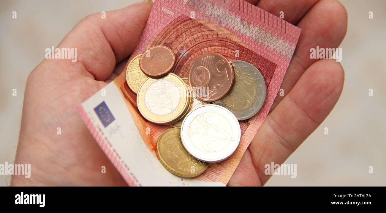 a handful of small money Stock Photo - Alamy