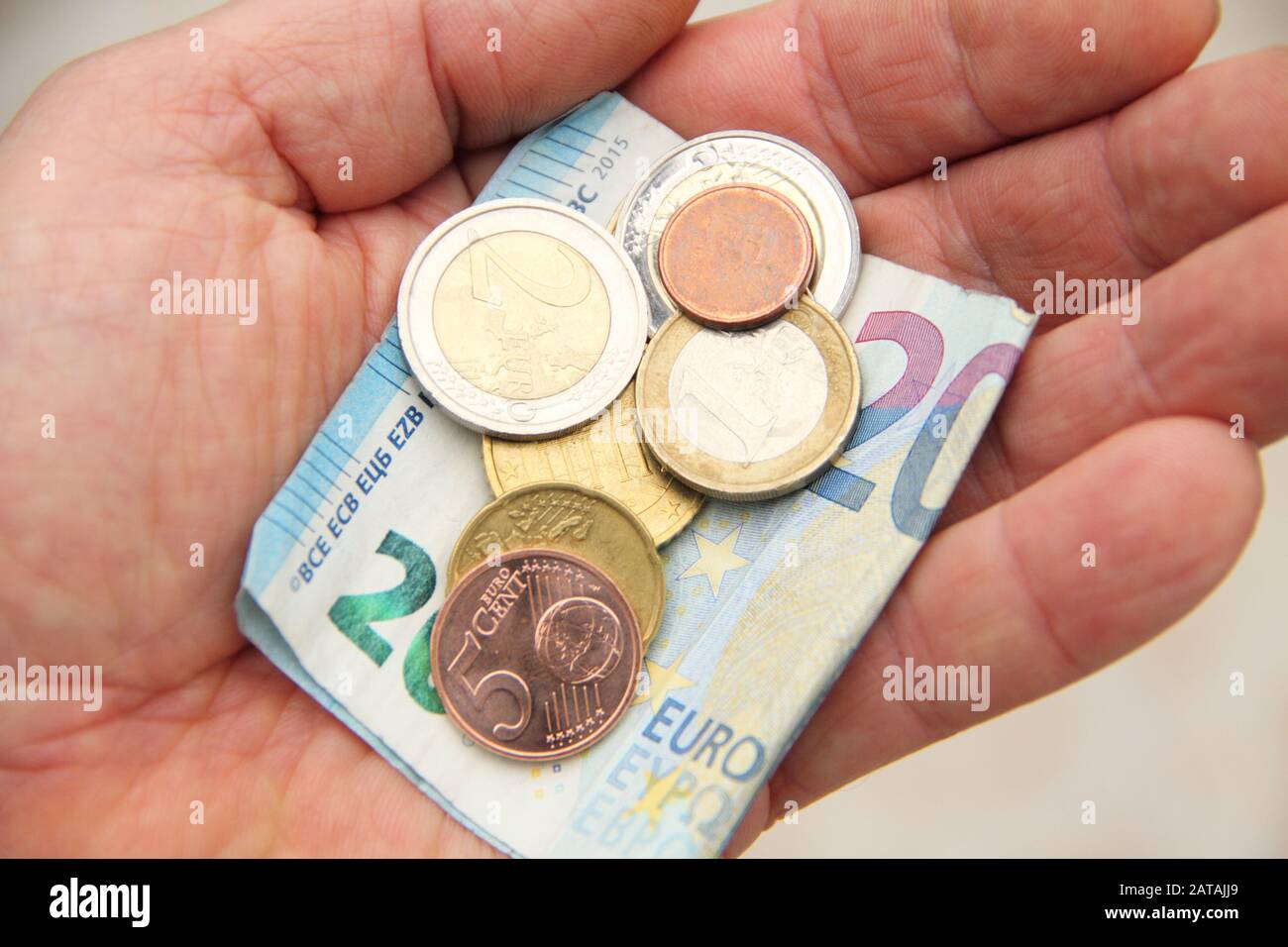 a handful of small money Stock Photo - Alamy