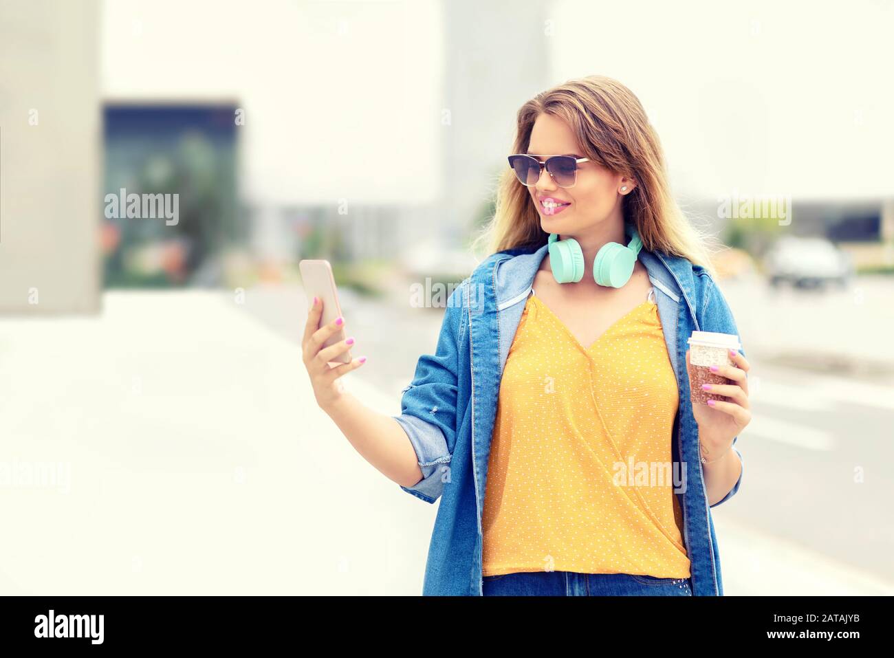 Modern young fashion woman influencer having fun at street using ...