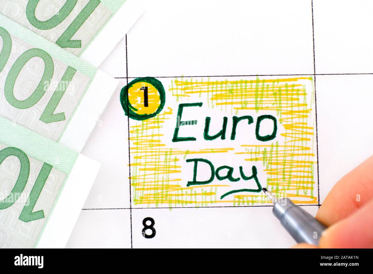 Woman fingers with pen writing reminder Euro Day in calendar with 100 ...