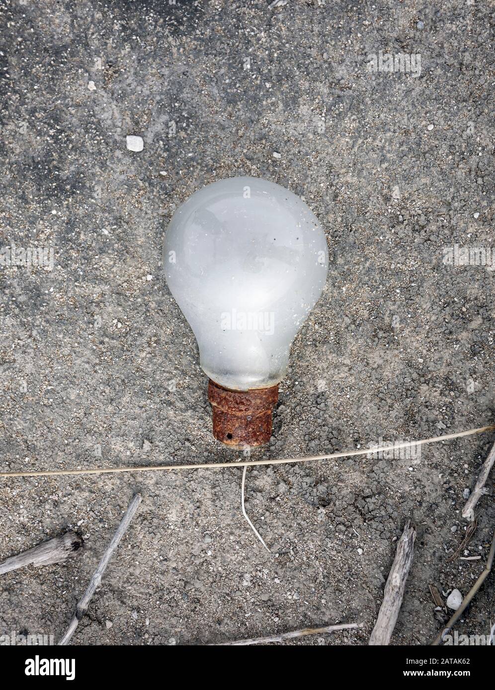 Old rusty light bulb on gray stone background Stock Photo - Alamy