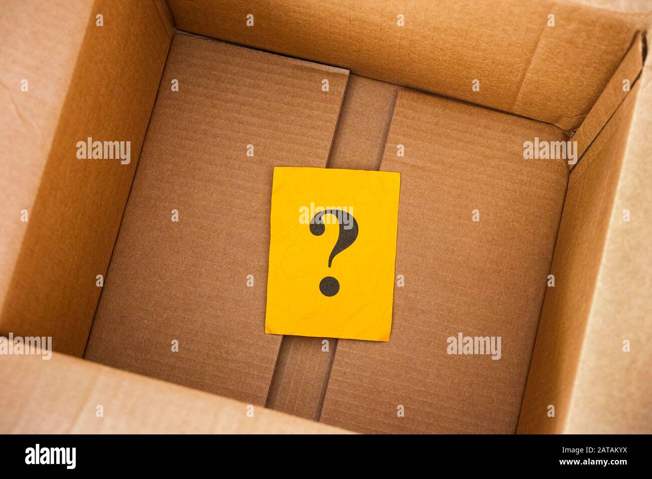 Question mark inside cardboard box. Close up Stock Photo - Alamy