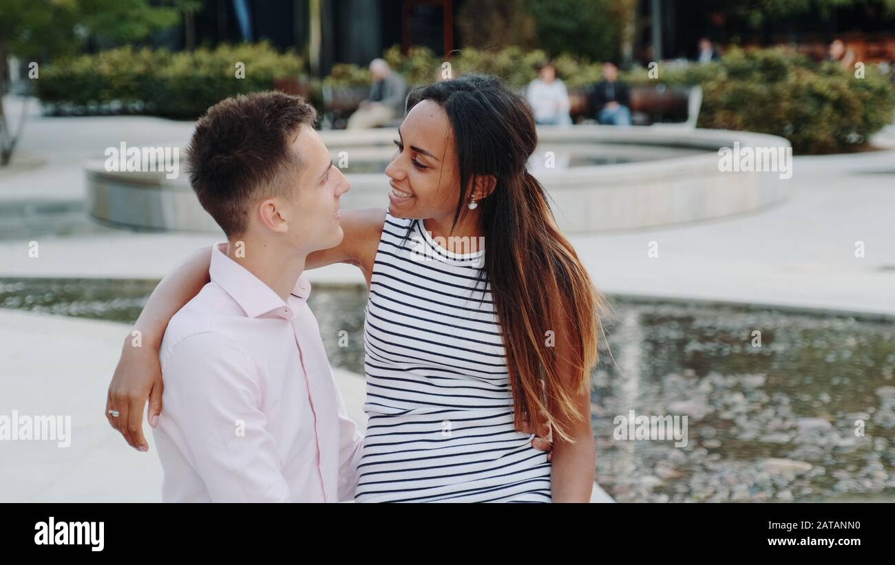 Multiracial couple hugging other in hi-res stock photography and images ...