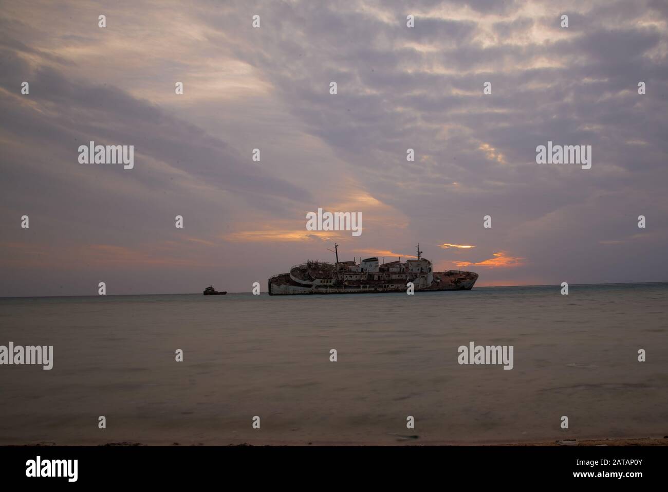 Al Qatan Beachand ship wreckage and Sun set Stock Photo - Alamy