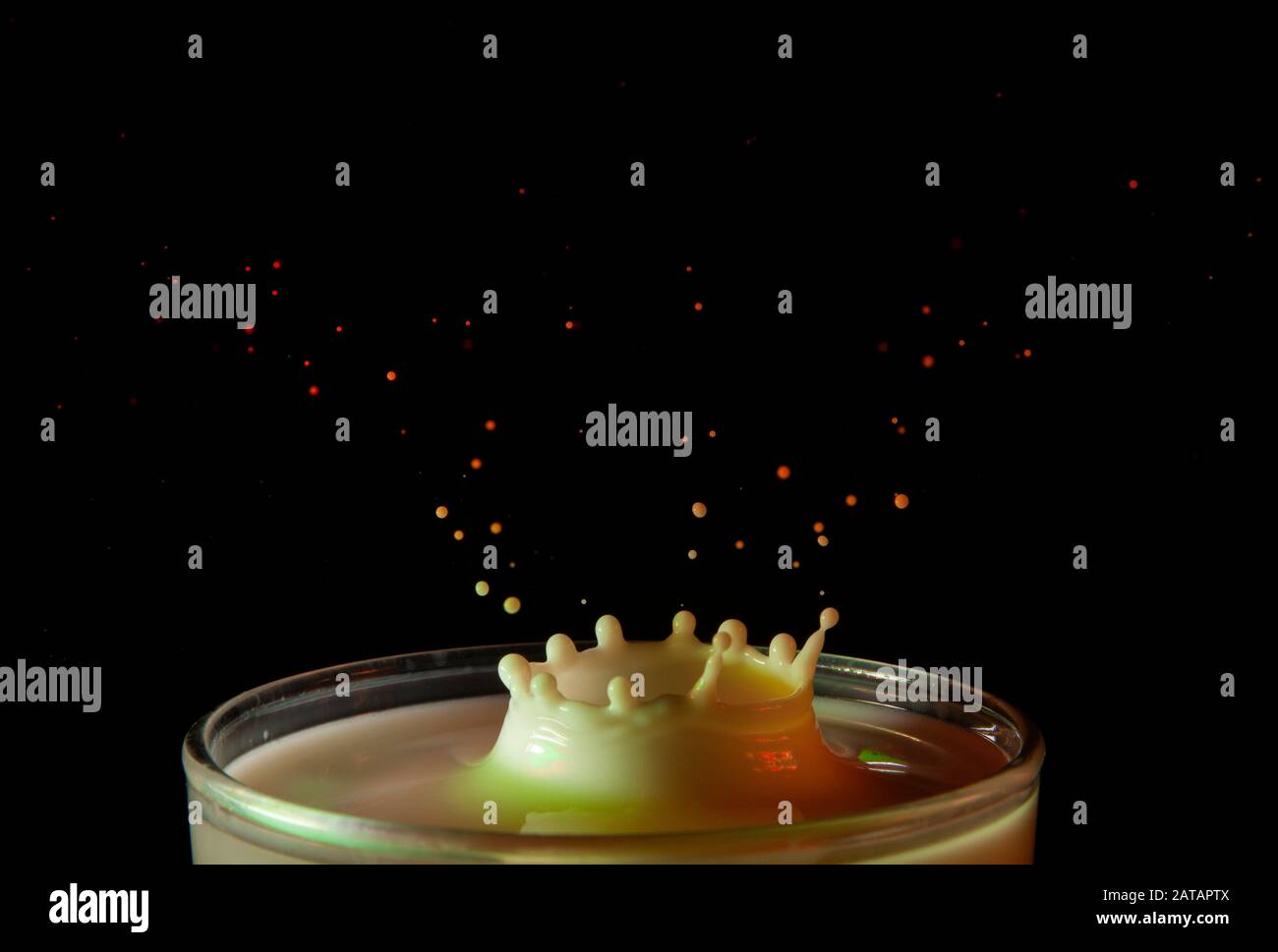 cream dropping in to a class Stock Photo - Alamy