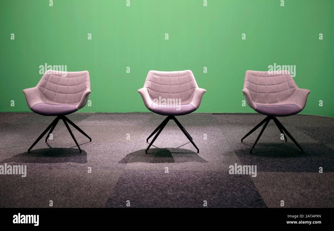 Three empty chairs in a studio with green screen Stock Photo - Alamy