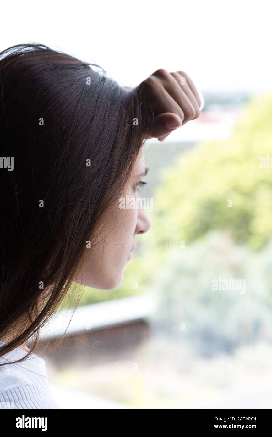 Face of Young Woman Leaning Head on Window Stock Photo - Alamy