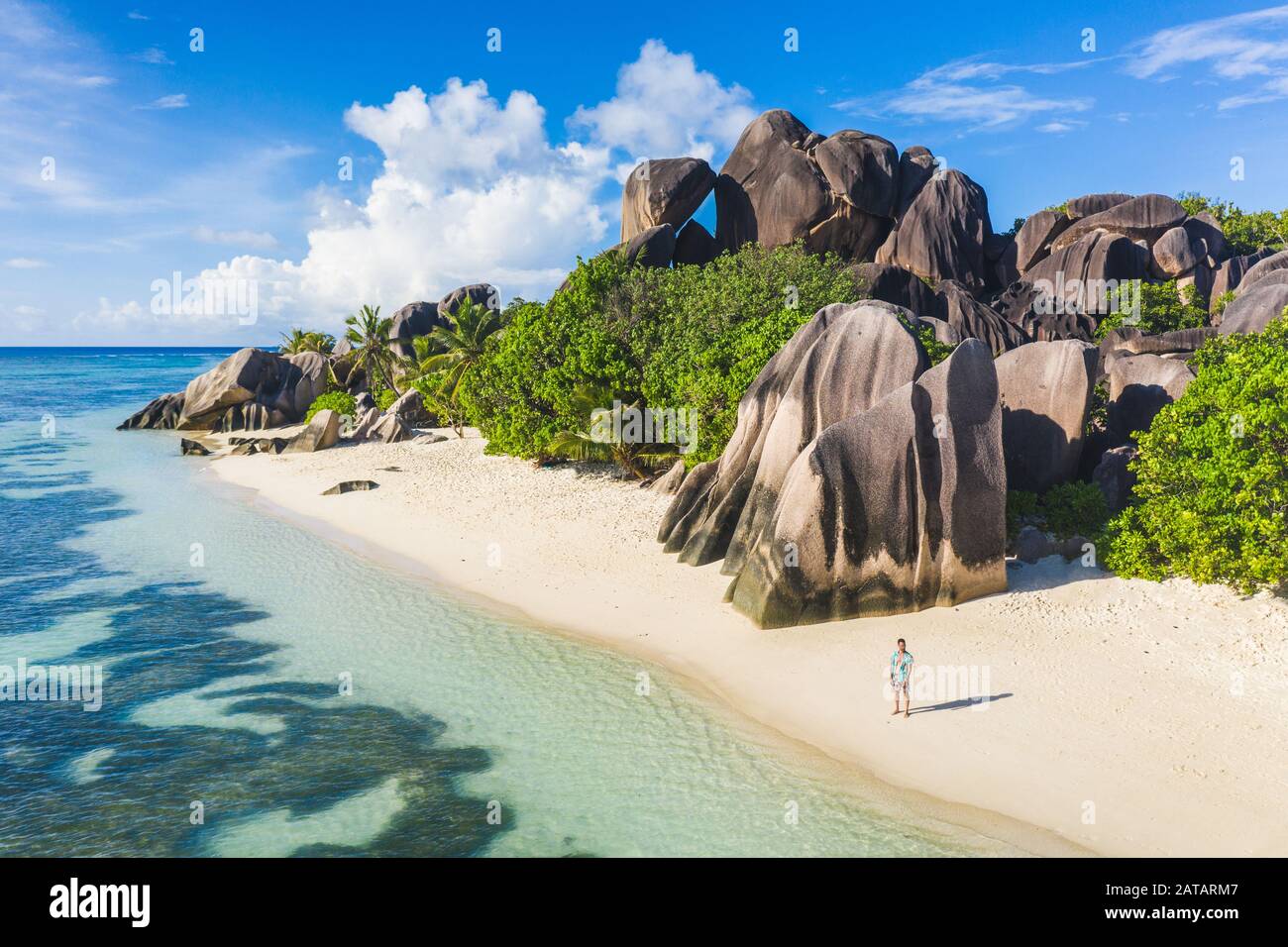Tourist on a beautiful beach with white sand on a tropical island in ...