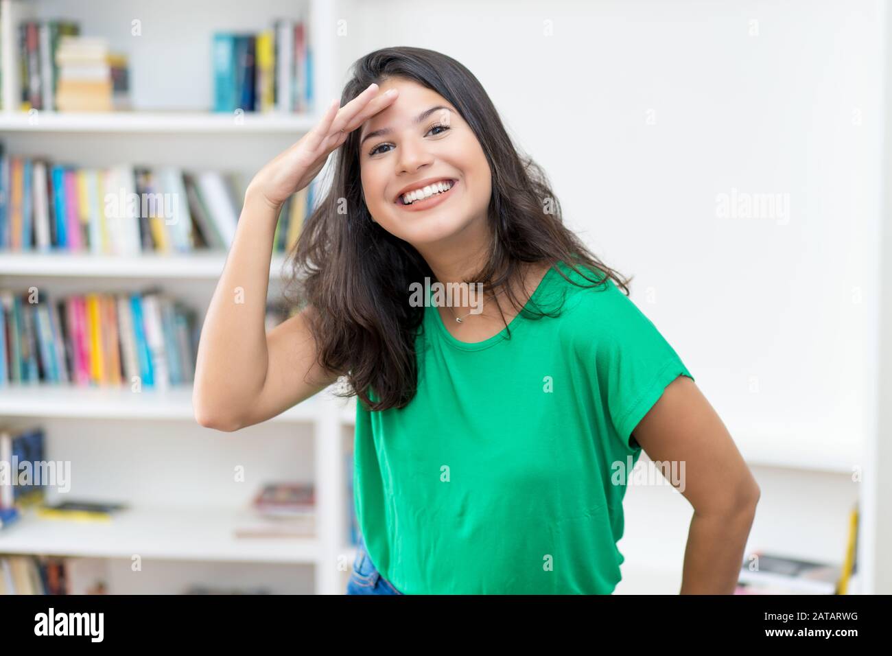 Pretty latin american young adult woman with long dark hair indoor at ...