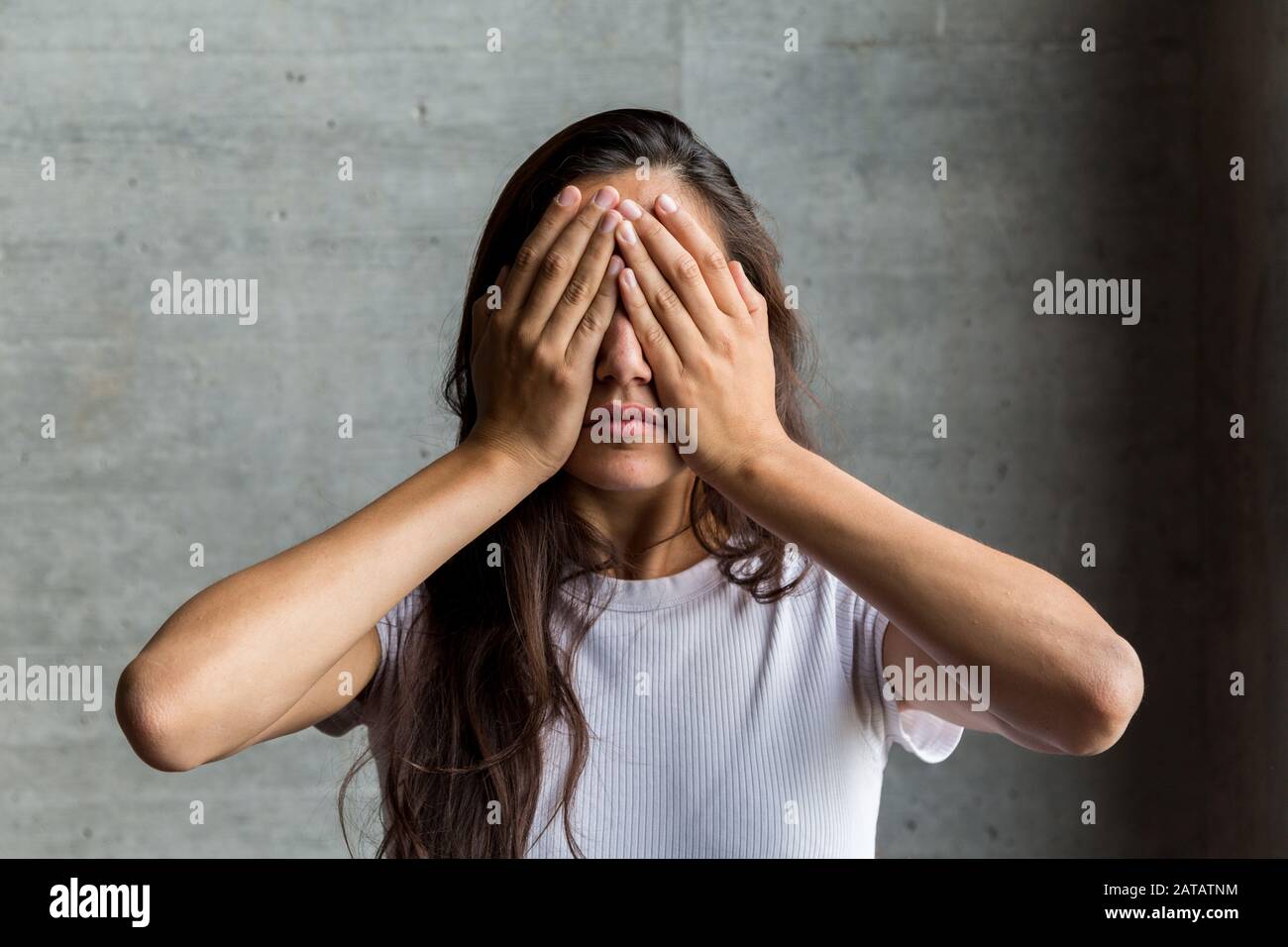 Young Woman Covering Eyes with Hands Stock Photo - Alamy