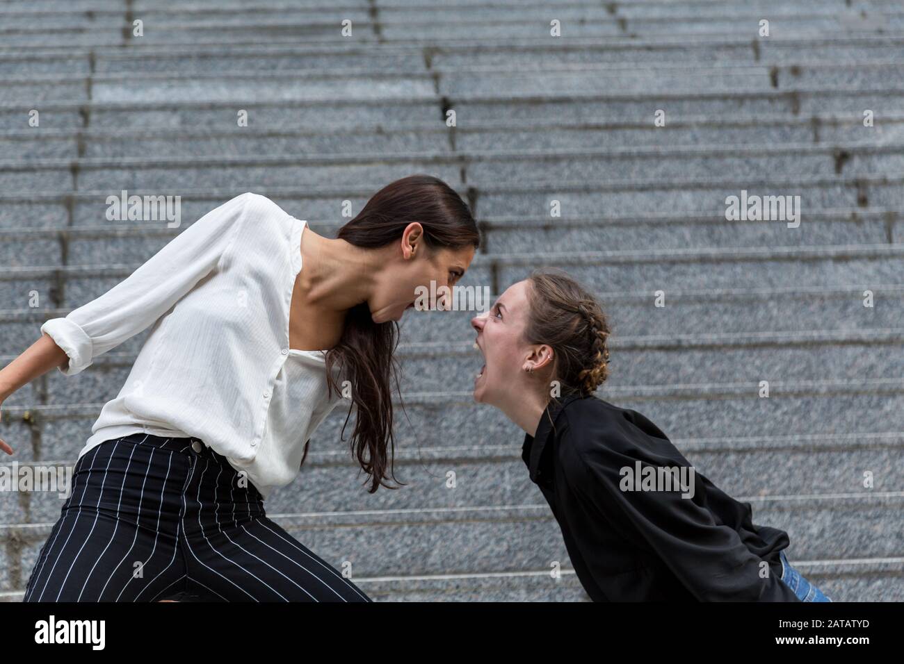 Two Women Screaming at Each Other Face to Face Stock Photo - Alamy