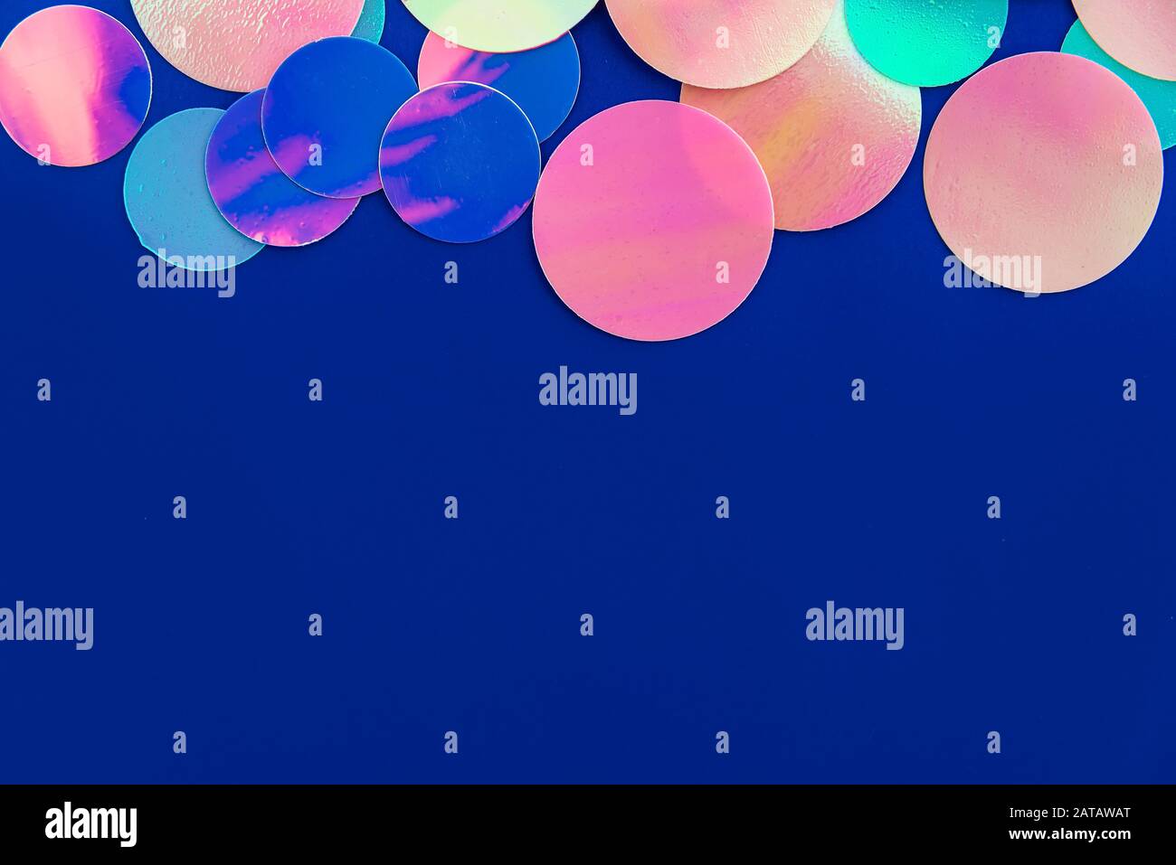 Border frame with big holographic sequins on classic blue background ...