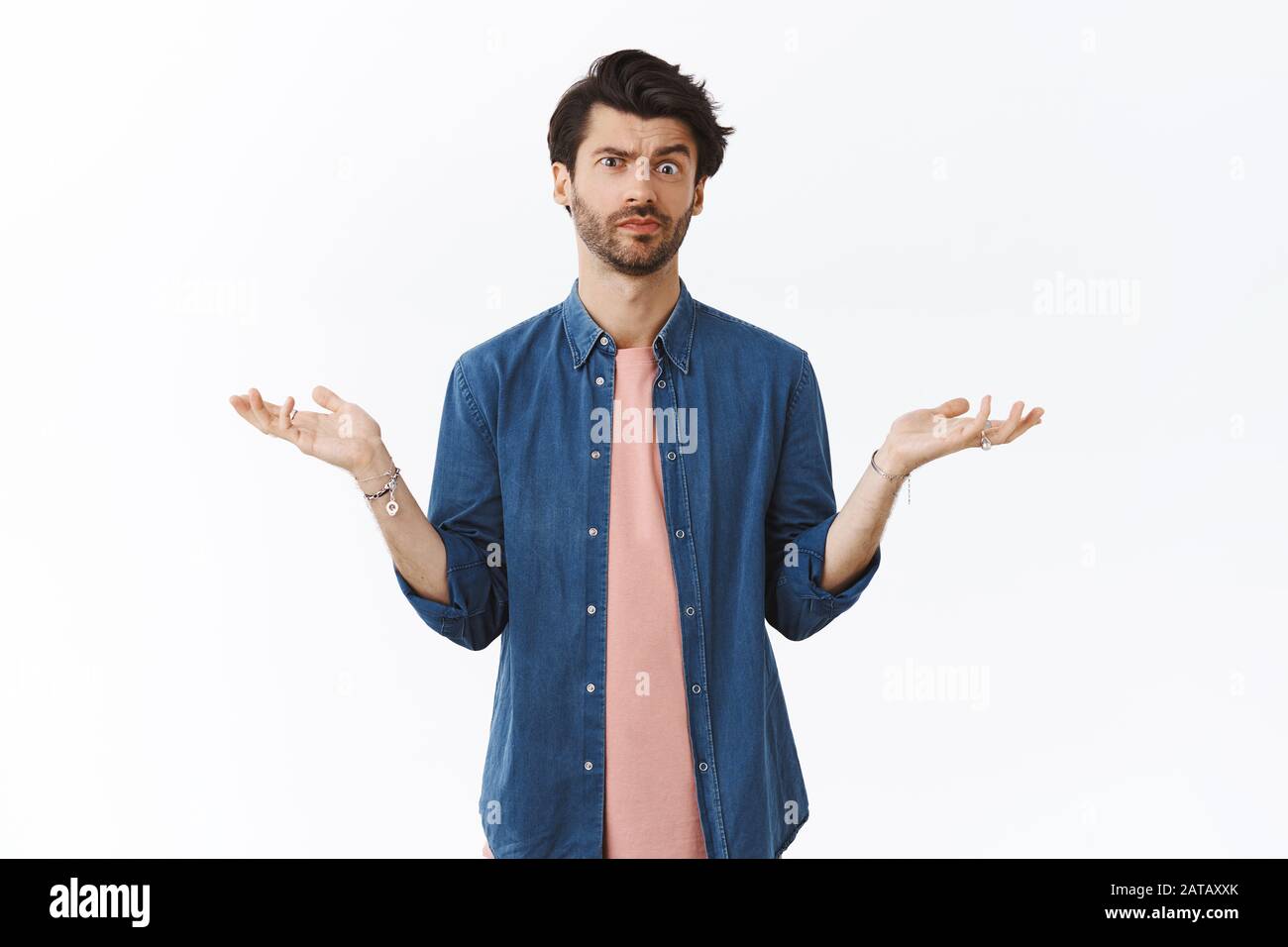 Skeptical or indecisive young handsome boyfriend spread hands sideways ...