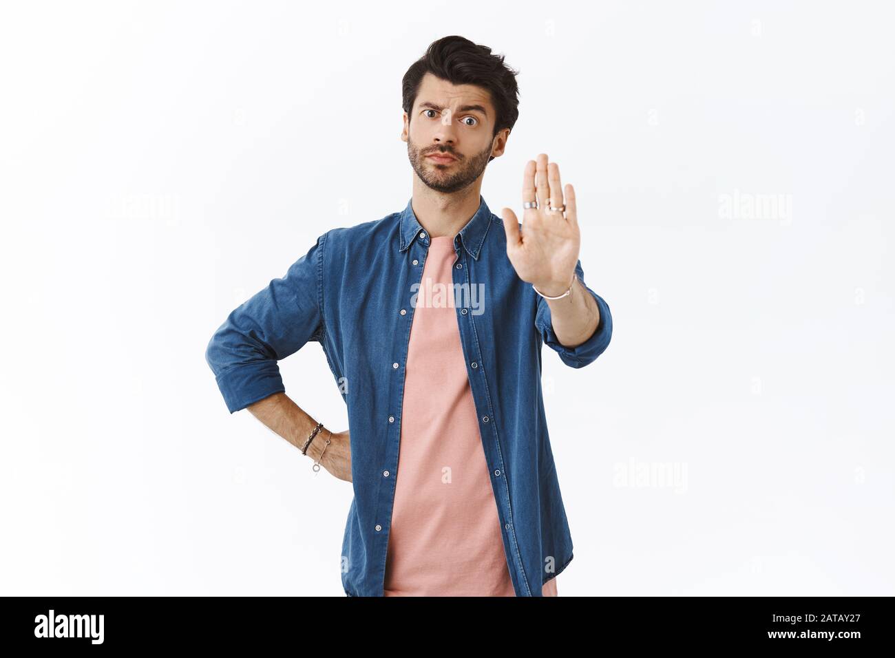 Stop right here. Serious-looking concerned and assertive handsome man ...