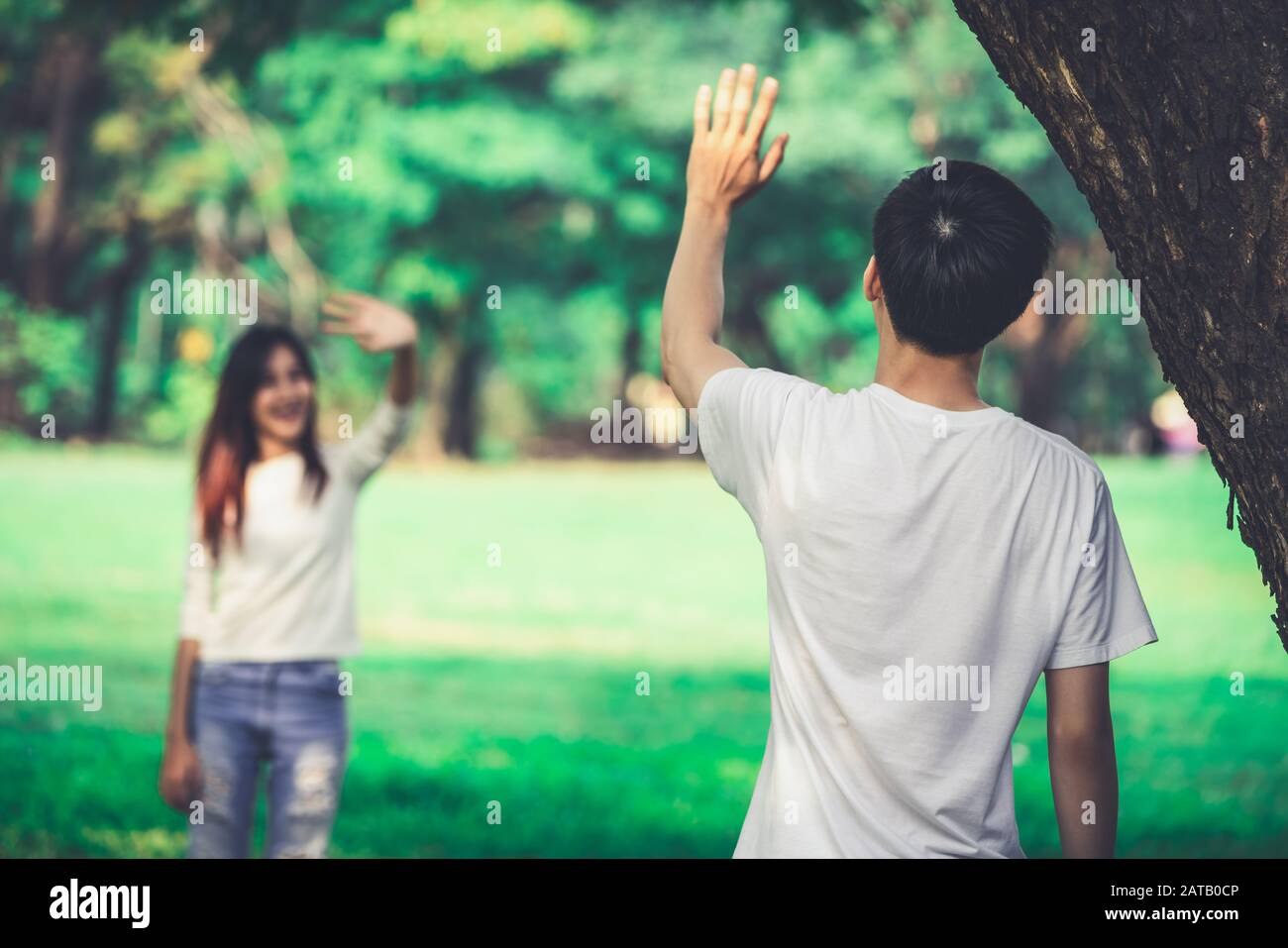 Two People Waving Goodbye