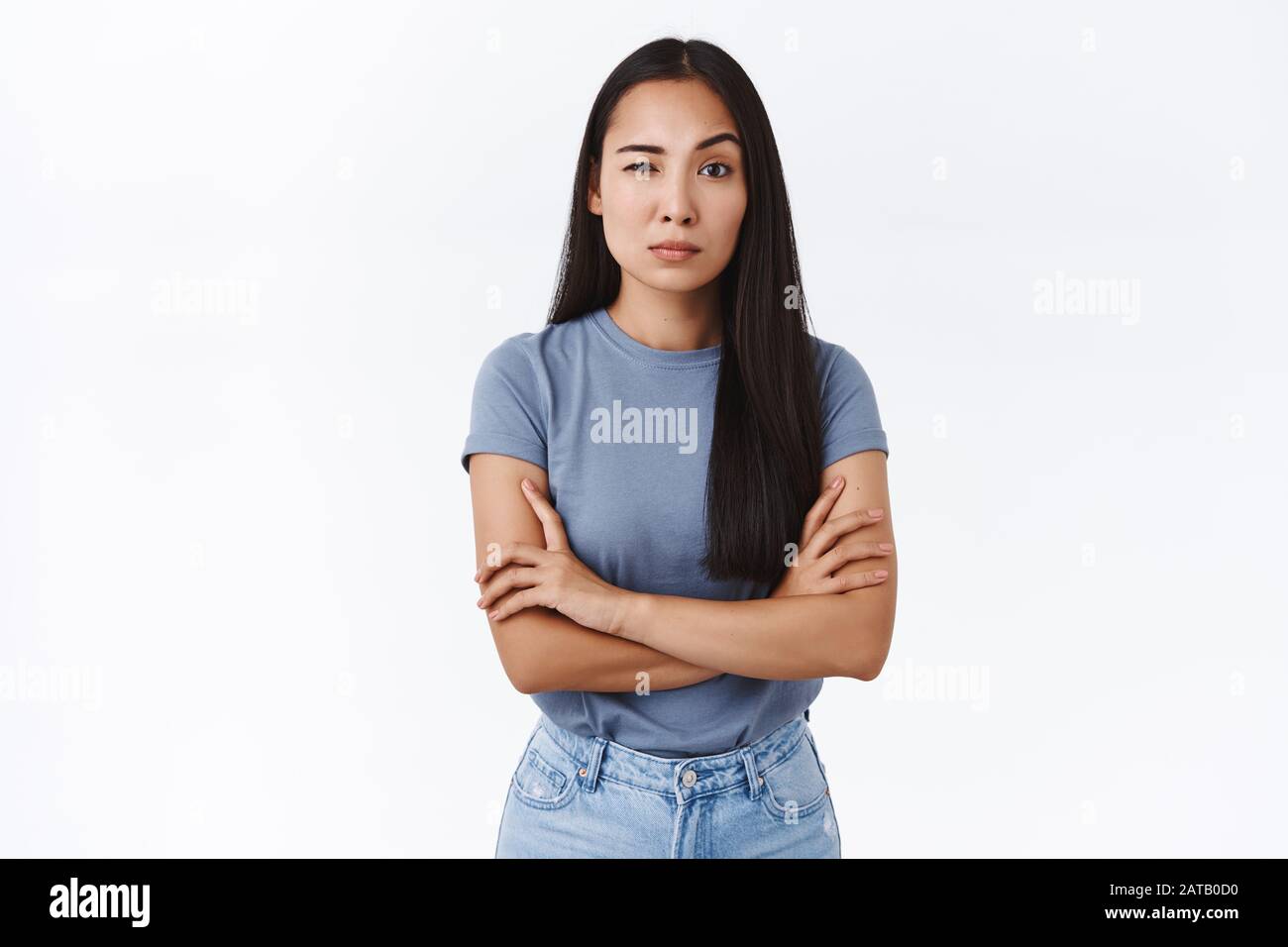 Skeptical and doubting young asian woman cross hands over chest in ...