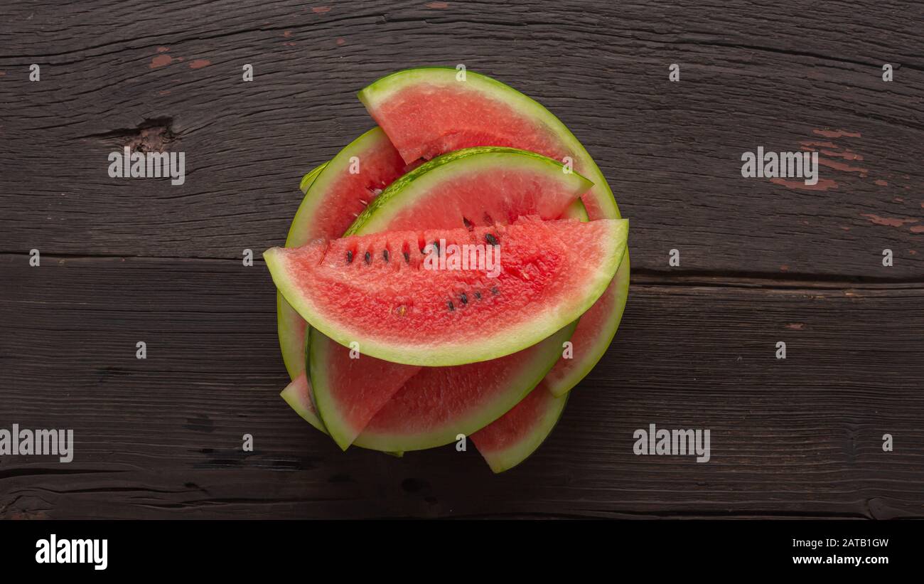 Ripe sliced watermelon on a wooden table. Top view, rustic style Stock ...
