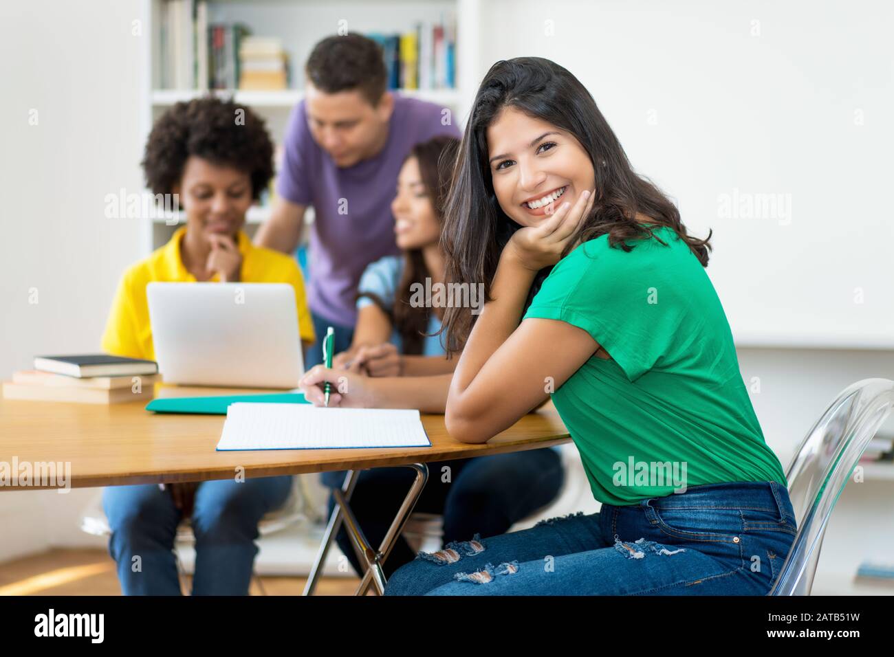Laughing female student with group of multi ehtnic students at ...