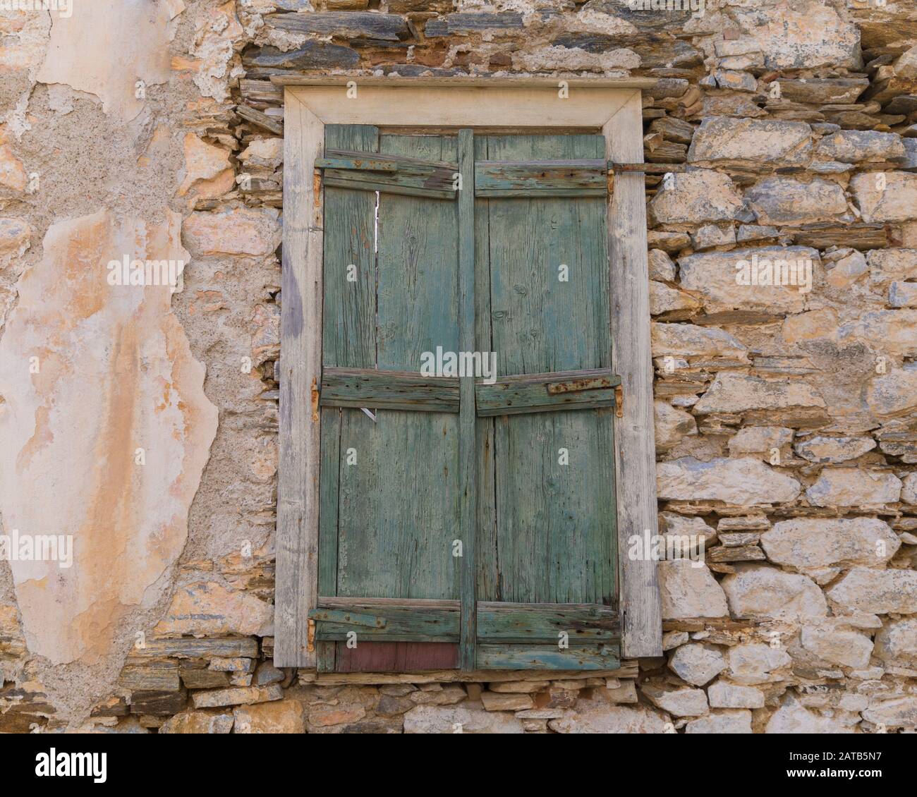 Old wooden weathered window on a old derelict stone wall in the ...