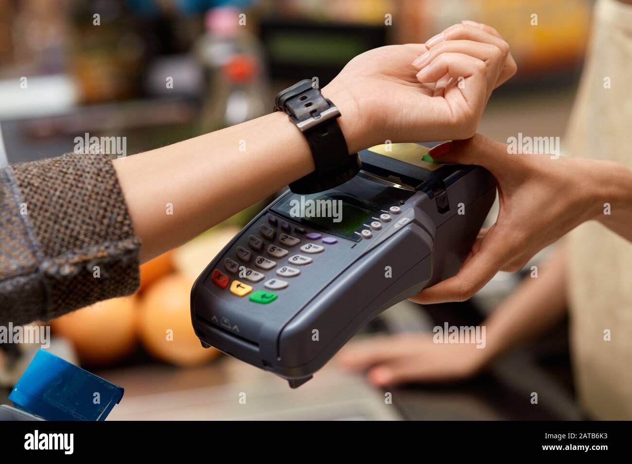 Daily Shopping. Woman standing at the supermarket cashier counter ...