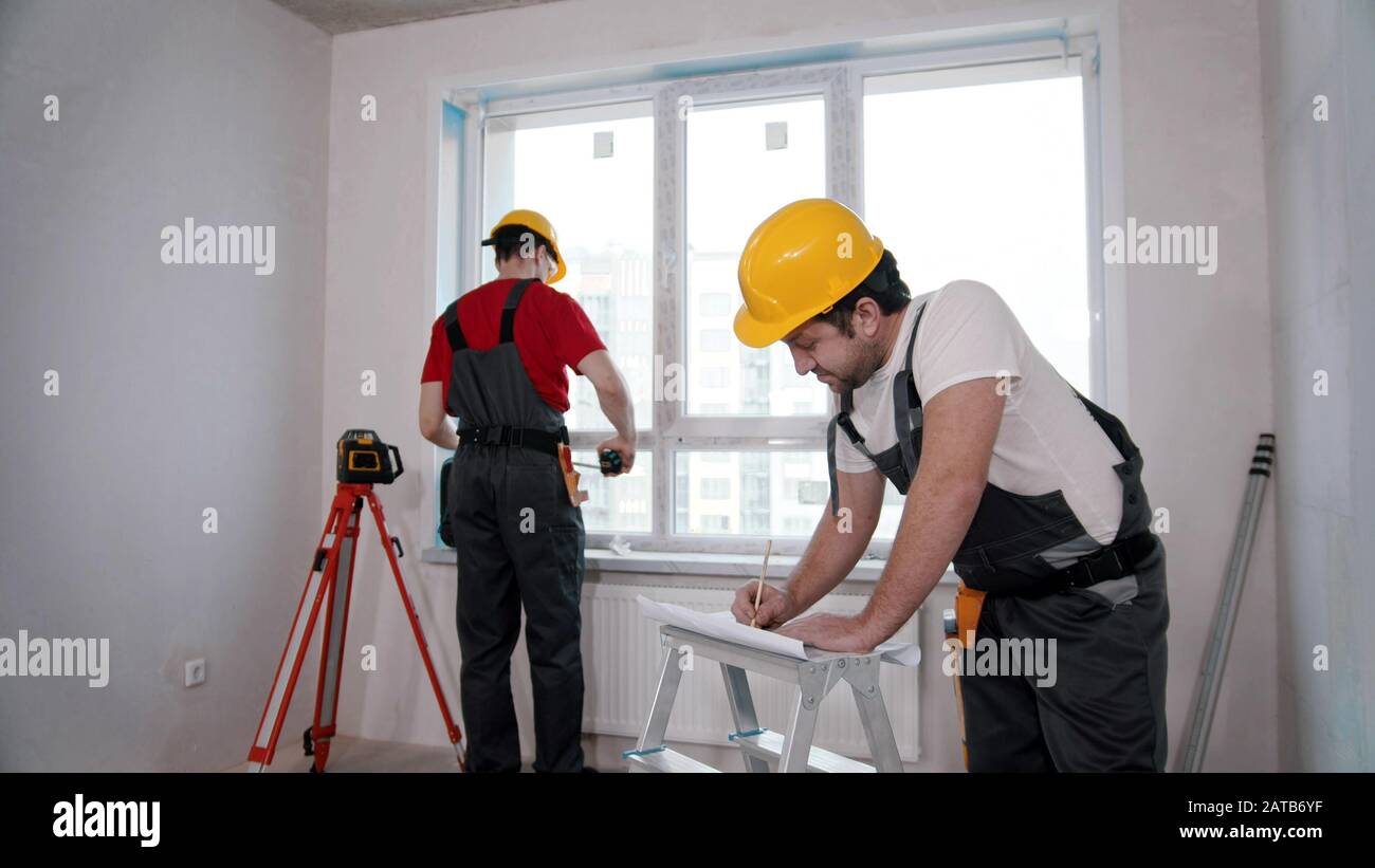 Two construction workers measuring hi-res stock photography and images ...