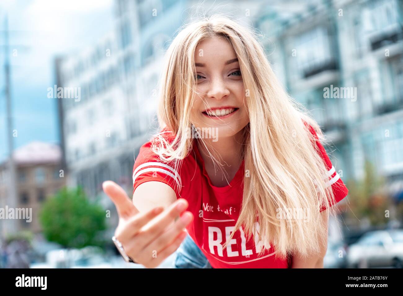 Outdoors Recreation. Teen girl walking on blurred urban background hand ...
