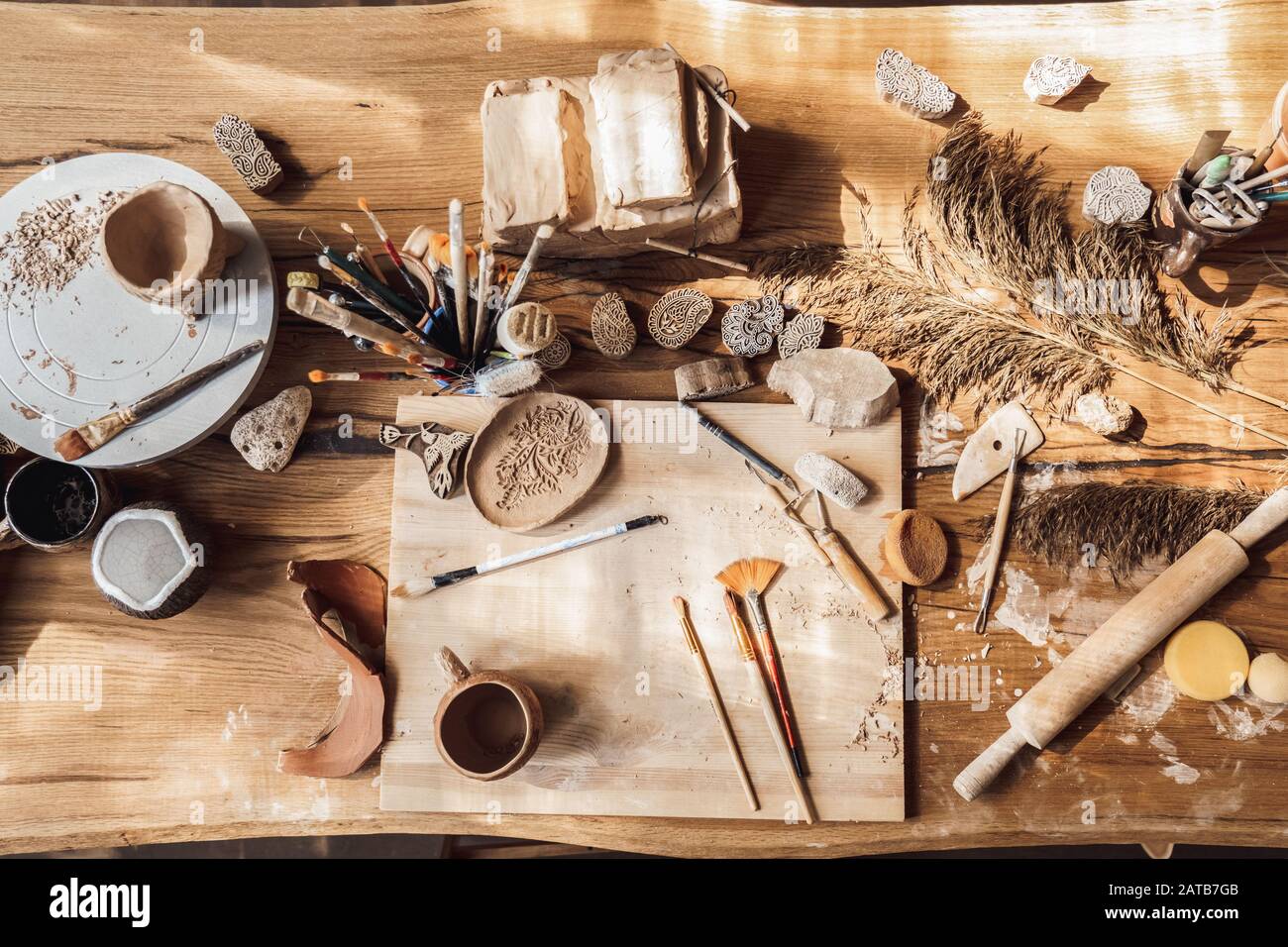 Craftsperson Workspace. Table with materials and tools for pottery ...