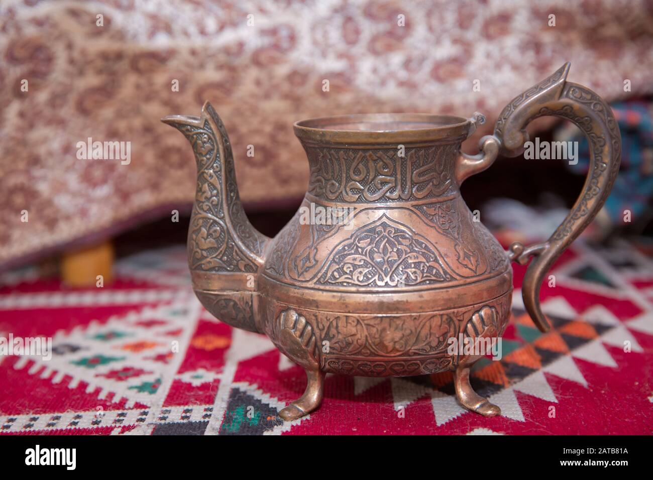vintage oriental teapot on a background of carpet .Beautiful vintage ...