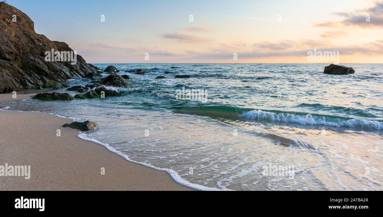 sunrise on the beach. beautiful summer scenery. rocks on the sand. calm ...