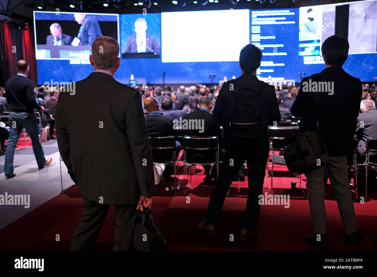 Audience members at a conference follow the presentation on stage Stock ...