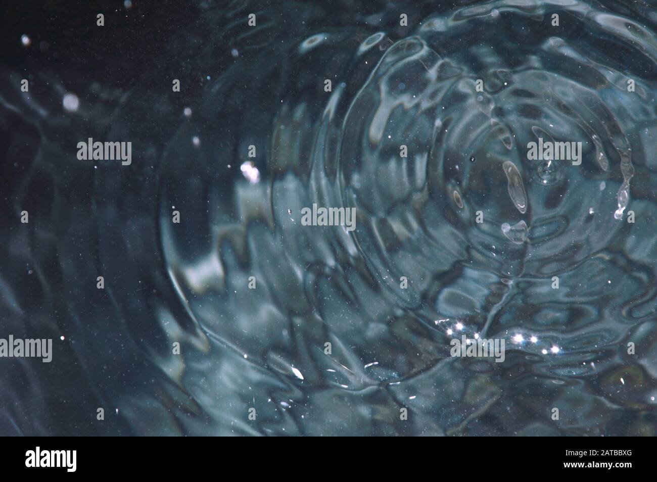 water spraying and drop on black background Stock Photo - Alamy