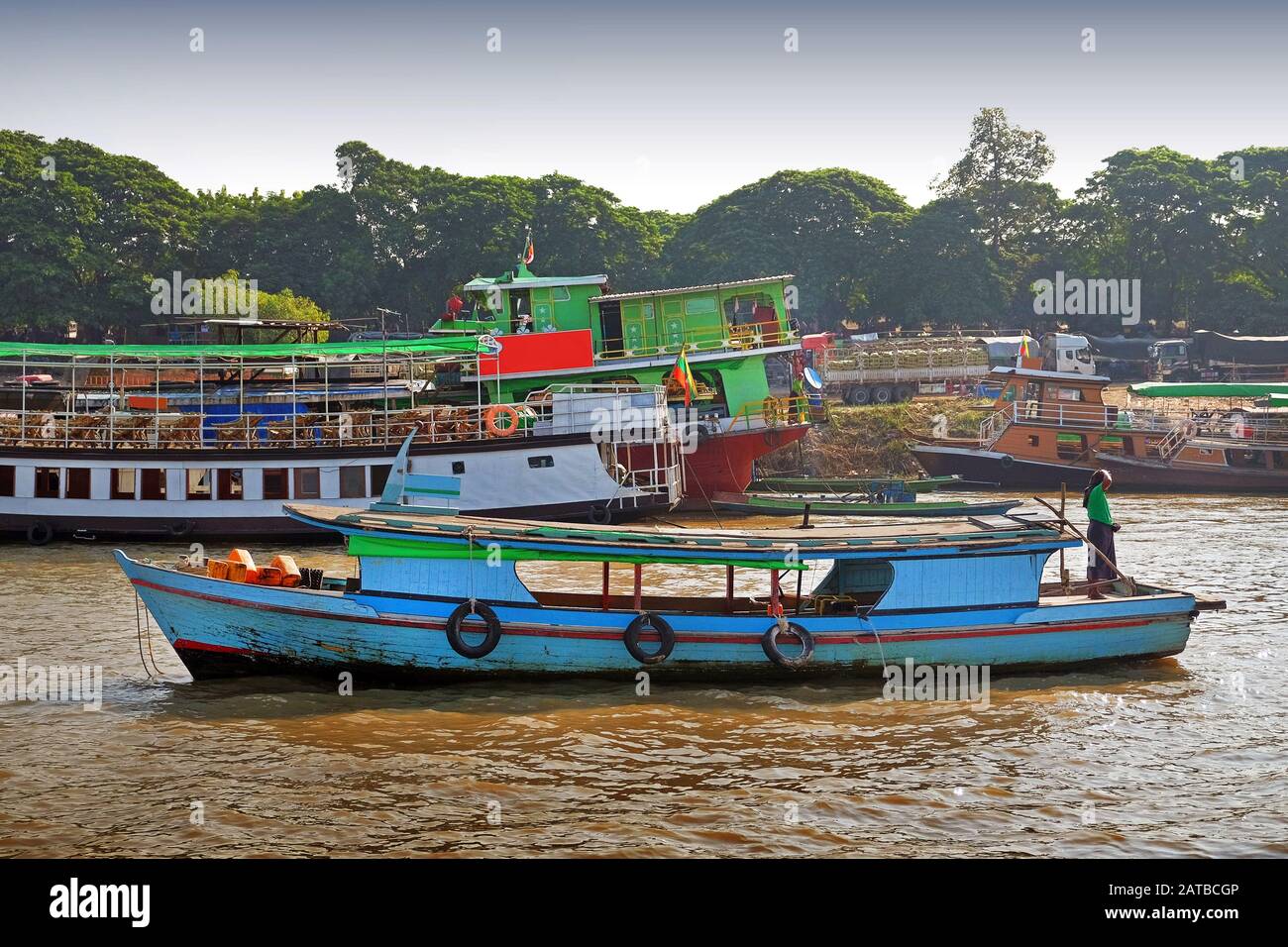 Traditional colorful Burmese boats on the Irrawaddy River, in the port ...