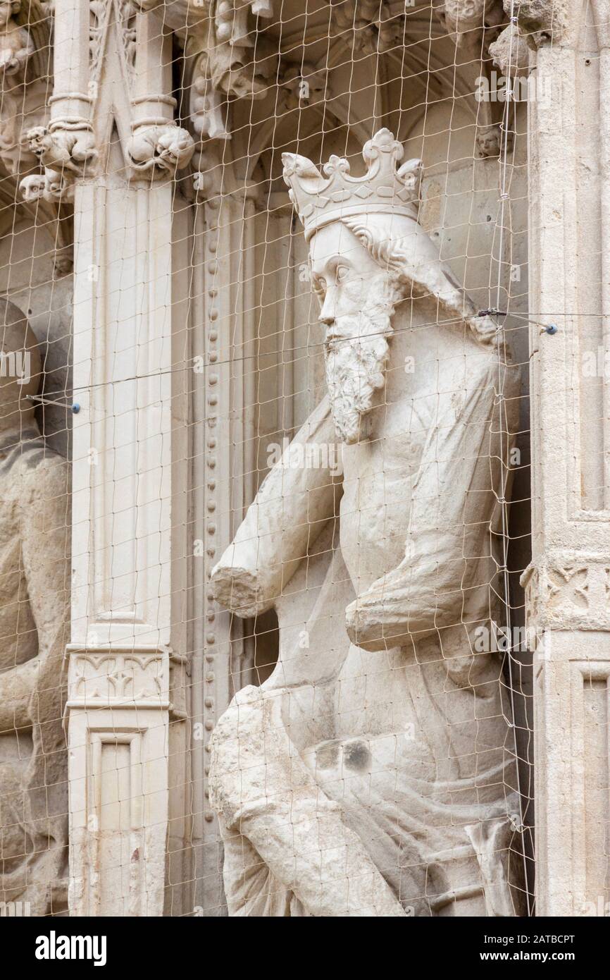 an old statue that is on the walls of Exeter cathedral in Devon ...
