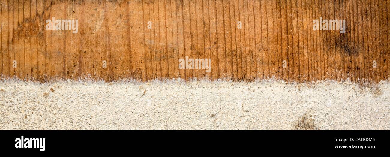 background texture of weathered barn wood with grain and white paint peeling off, panoramic ...