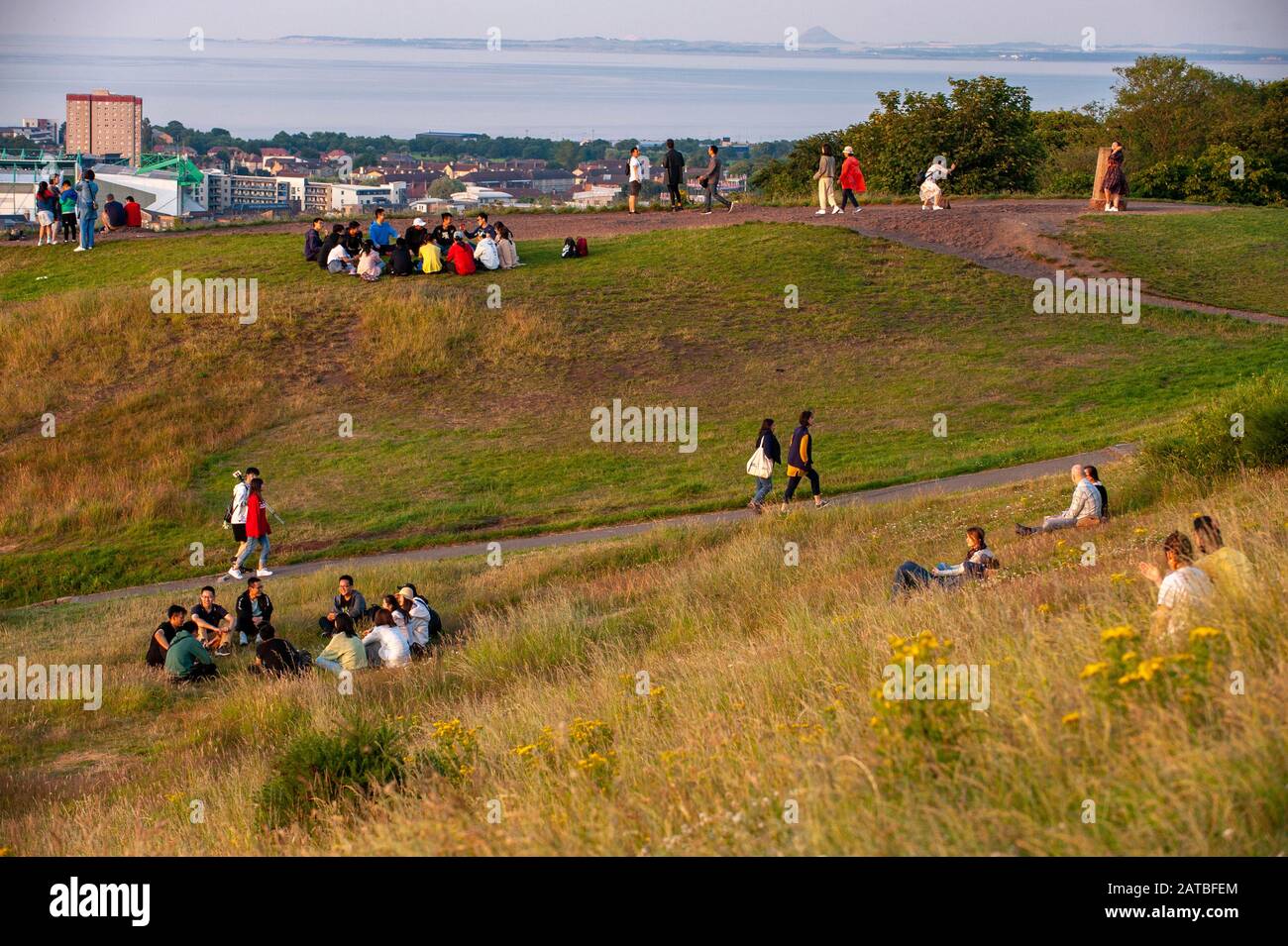 People enjoying the sunset in Calton Hill. Edinburgh cityscape/travel ...