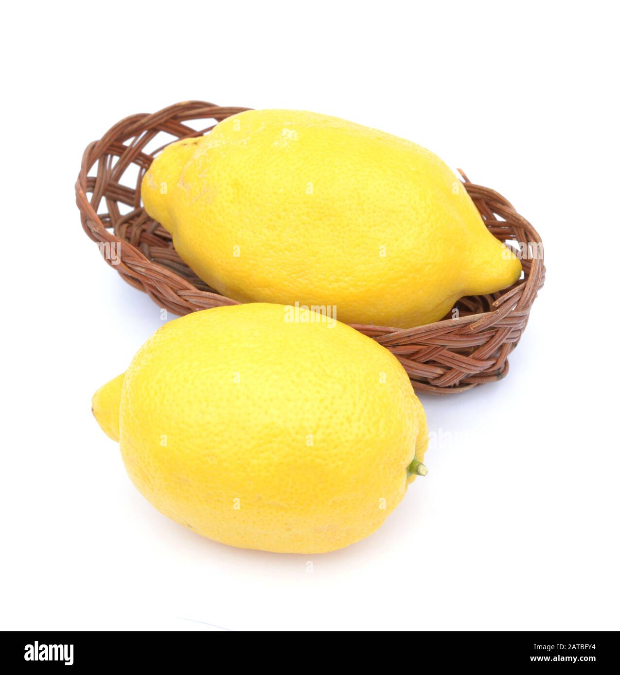 Two lemon fruit on bamboo bucket on white Stock Photo - Alamy