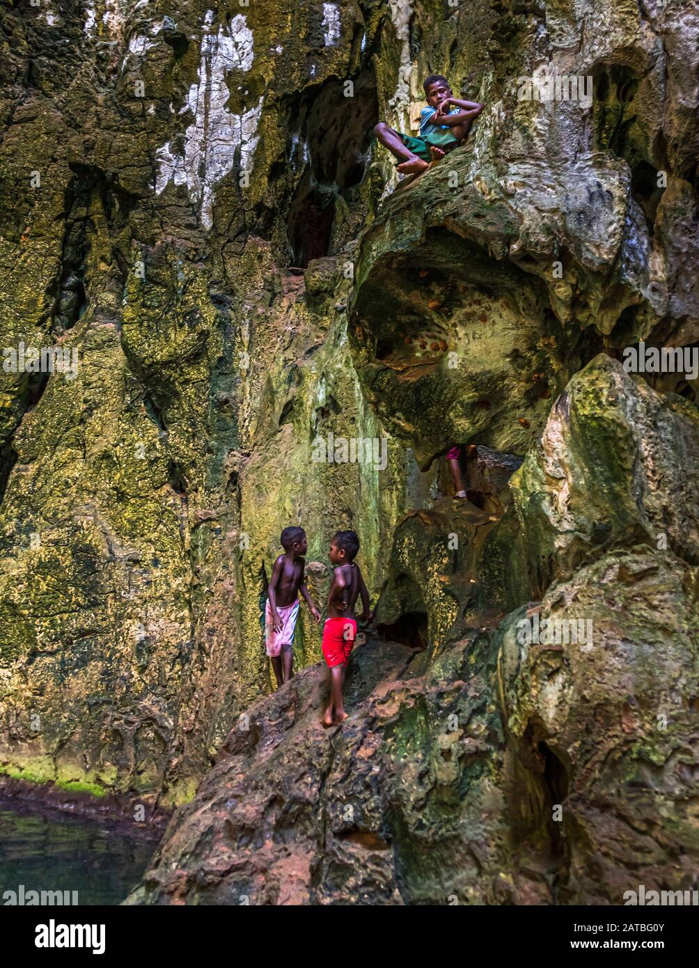 Locals in a brackish water cave on Panasia Island, Papua New Guinea ...