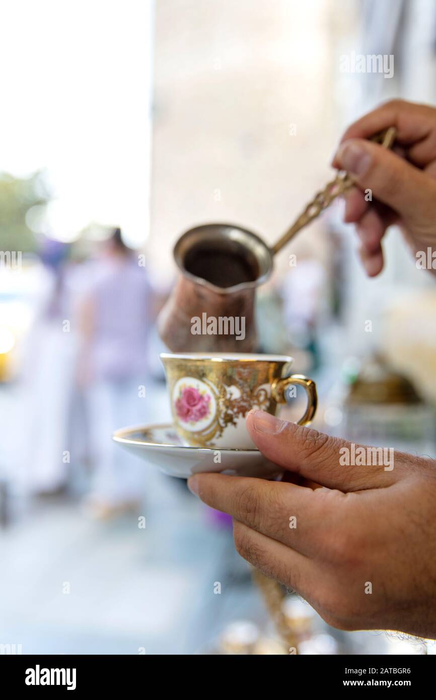 Traditional turkish coffee in cezve prepared on hot sand. Selective ...
