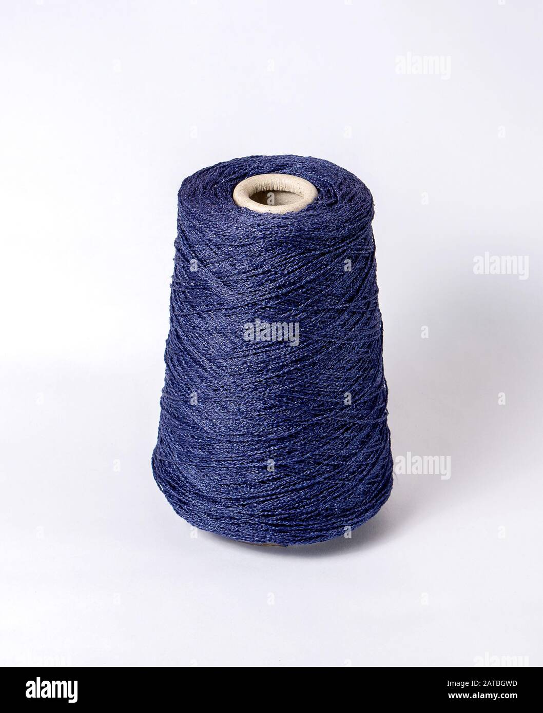 bobbin of yarn on a white background. Side view.Textile reel on ...